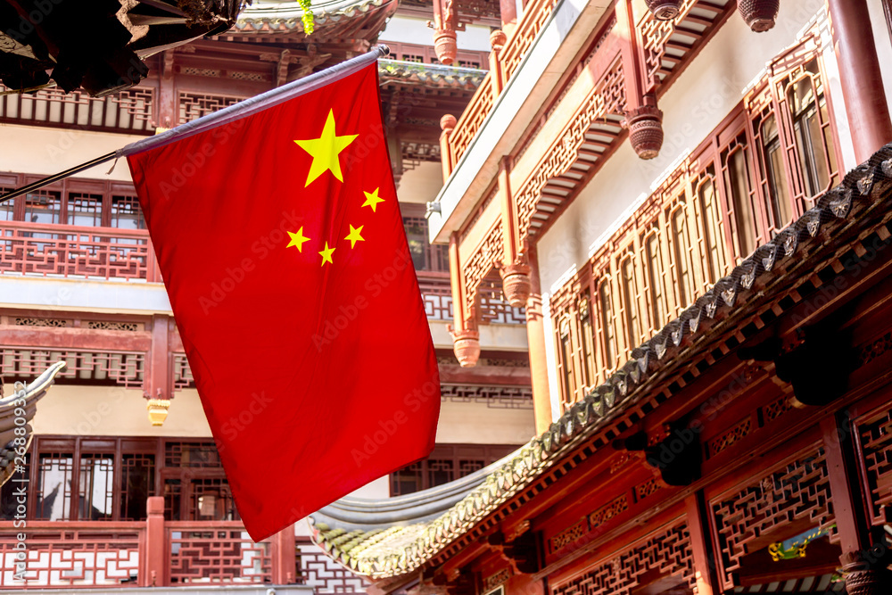 Red national flag of China against old chinese buildings at Yuyuan ...