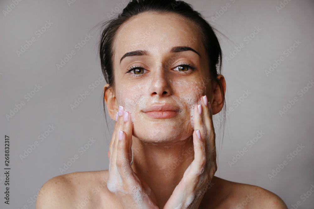girl washing her face with a cleansing gel in the bathroom Stock Photo ...