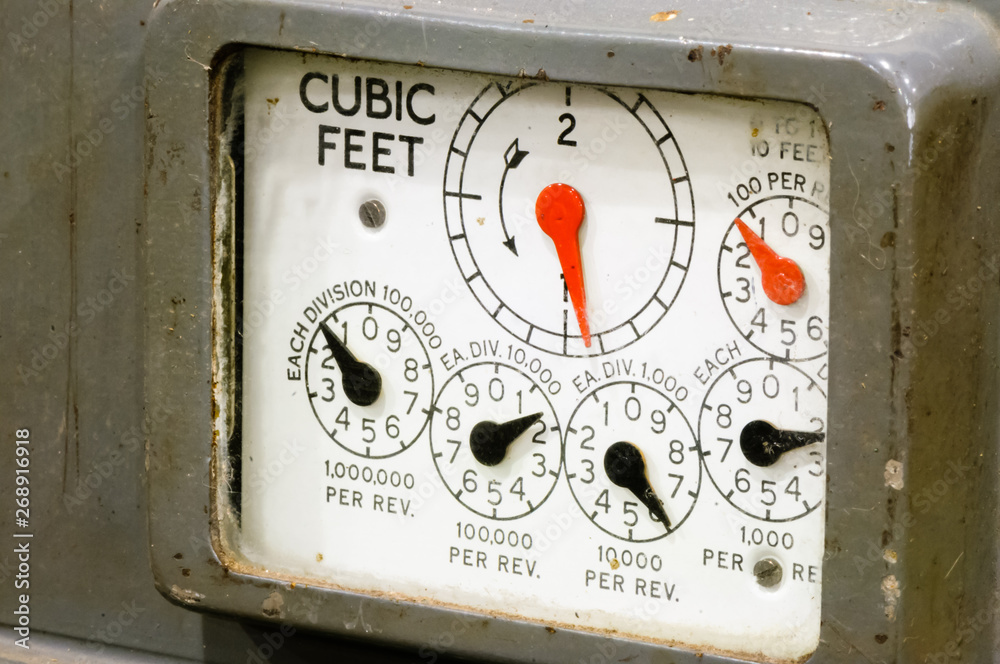 Close-up of dials on an old fashioned gas meter from the 1920s/1930s ...
