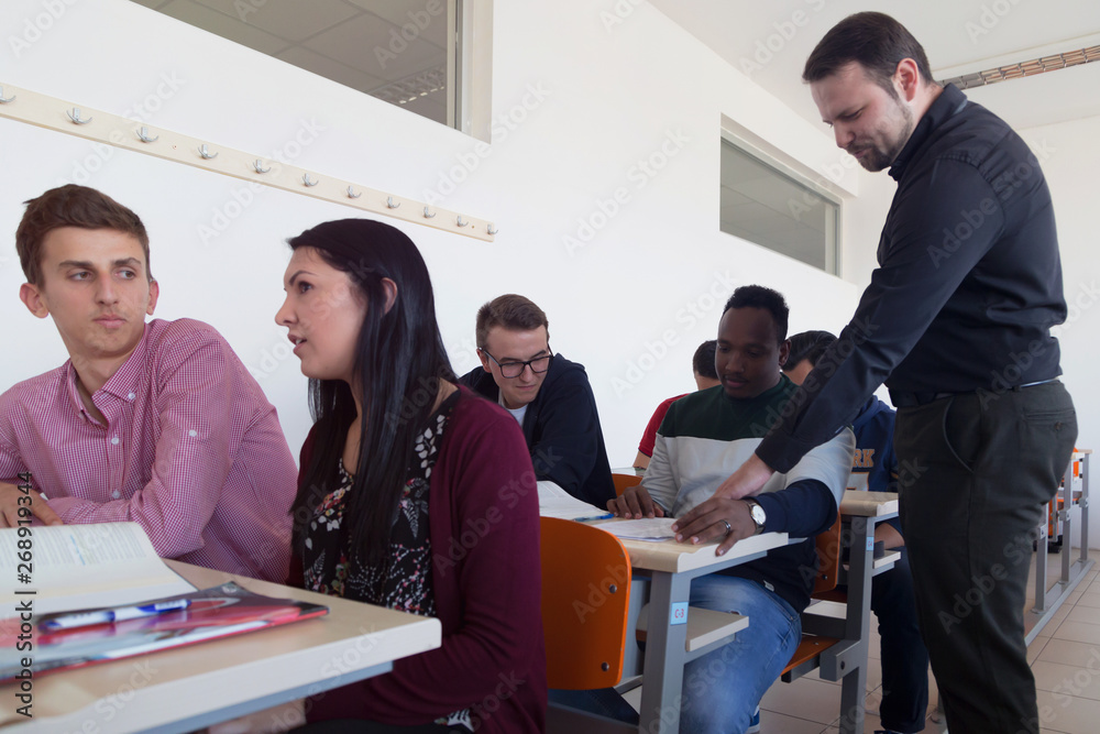 Male professor explain lesson to students and interact with them in the ...