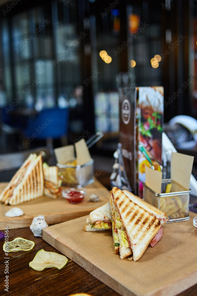 Cafe menu displaying - sets of sandwiches with chicken fillet, sausages ...