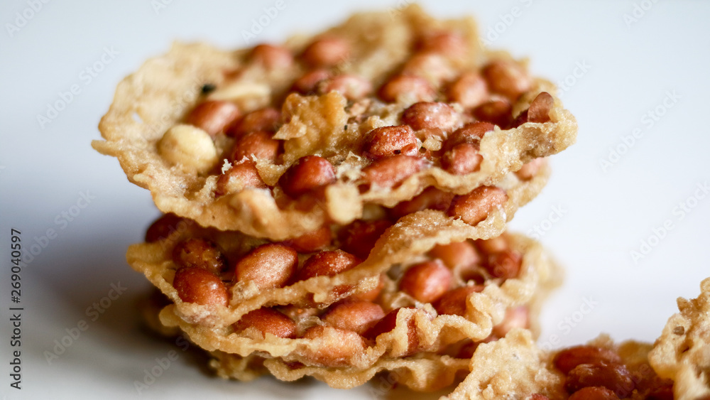 Peanut Peyek on white background. Peanut Rempeyek or Peyek is a deep ...