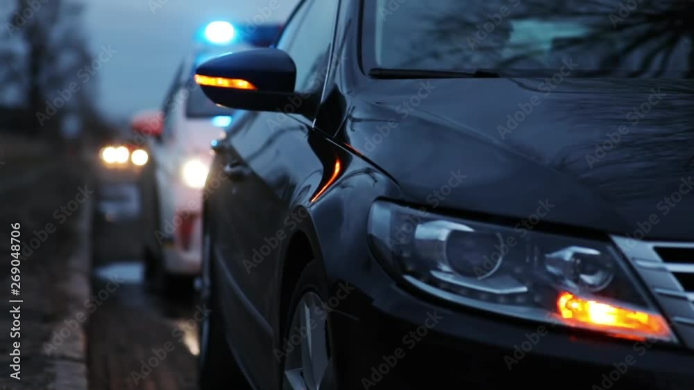 Side view of the modern car and the police parked on the roadside. Cars ...