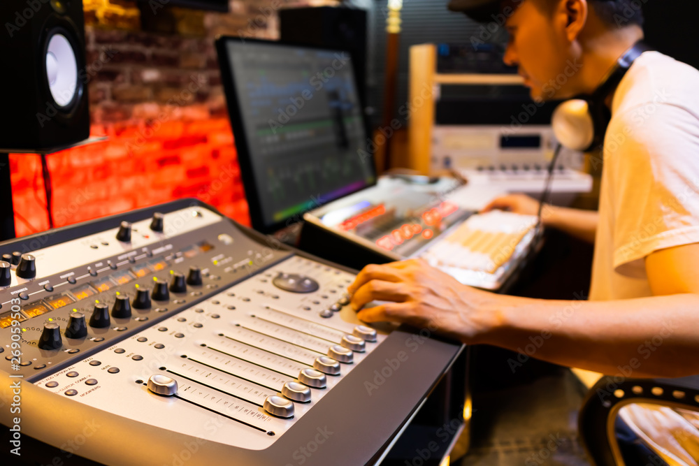 asian male professional sound engineer working in recording ...