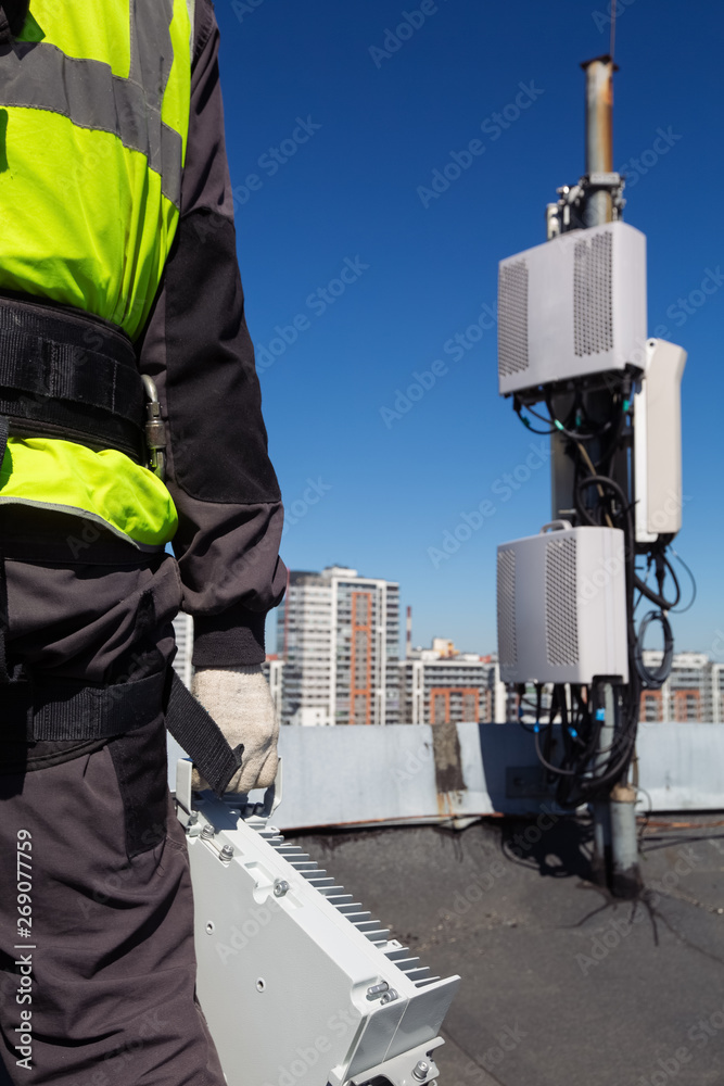 Professional industrial climber in helmet and uniform holds ...