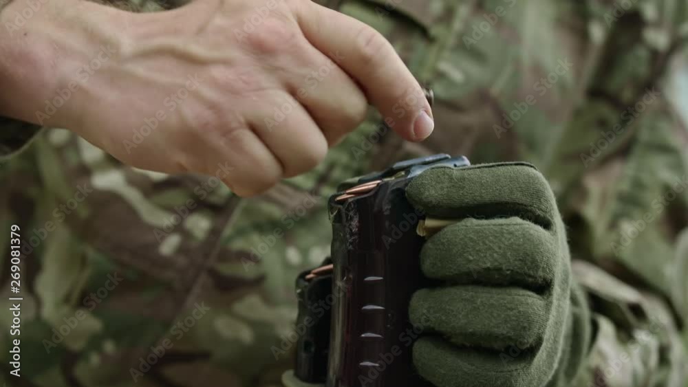 Kalashnikov rifle charging. Close up of charging rifle. AK 47 loading ...