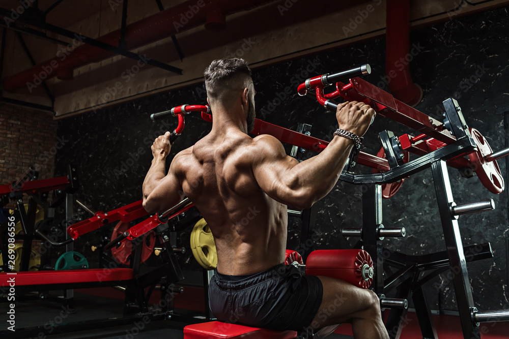 Young handsome sportsman bodybuilder weightlifter with an ideal body ...