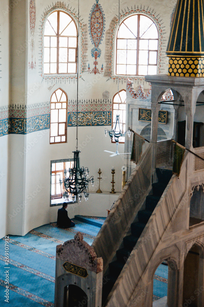 Muslim believer praying inside a mosque, grain film added. Stock Photo ...