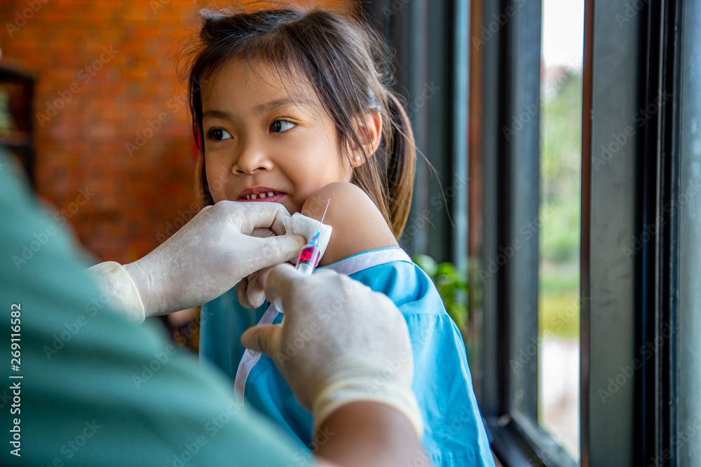 Doctor injection immunization Asian cute girl patient in hospital ...