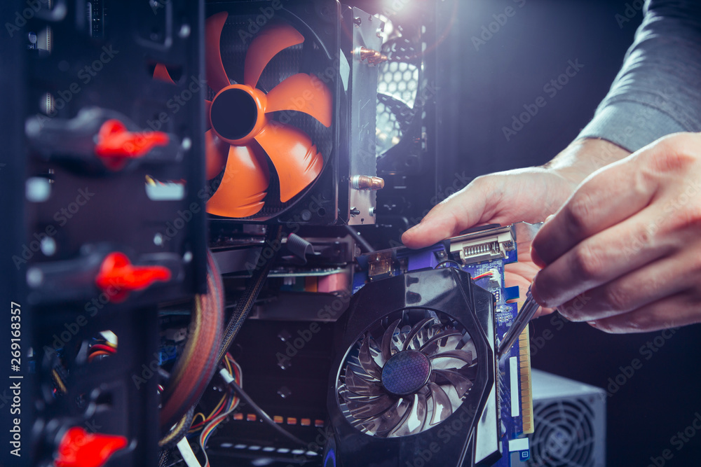 Technician repairing a computer, the process of replacing components on ...