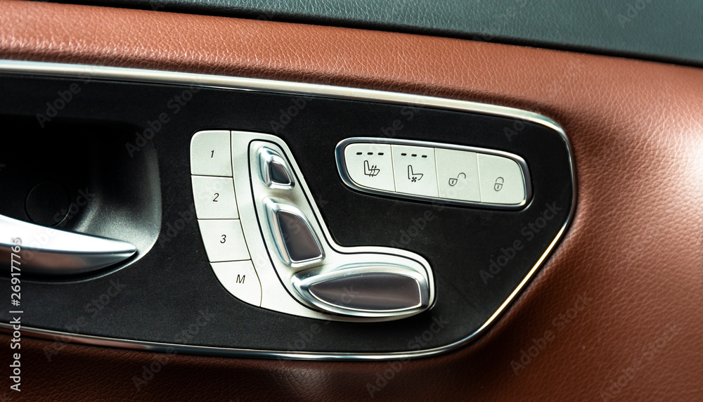 Door handle with Power seat control buttons of a luxury passenger car ...