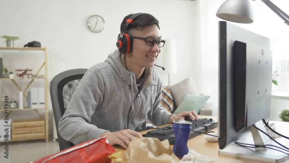 Excited male gamer playing winning online video game on personal ...