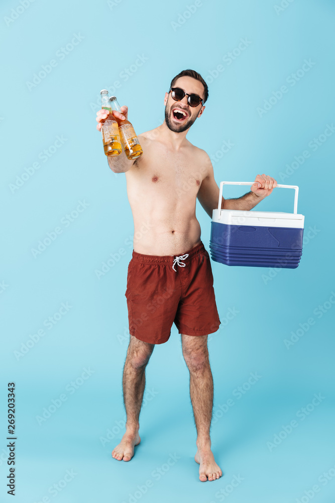 Full length photo of brunette shirtless man wearing sunglasses smiling ...