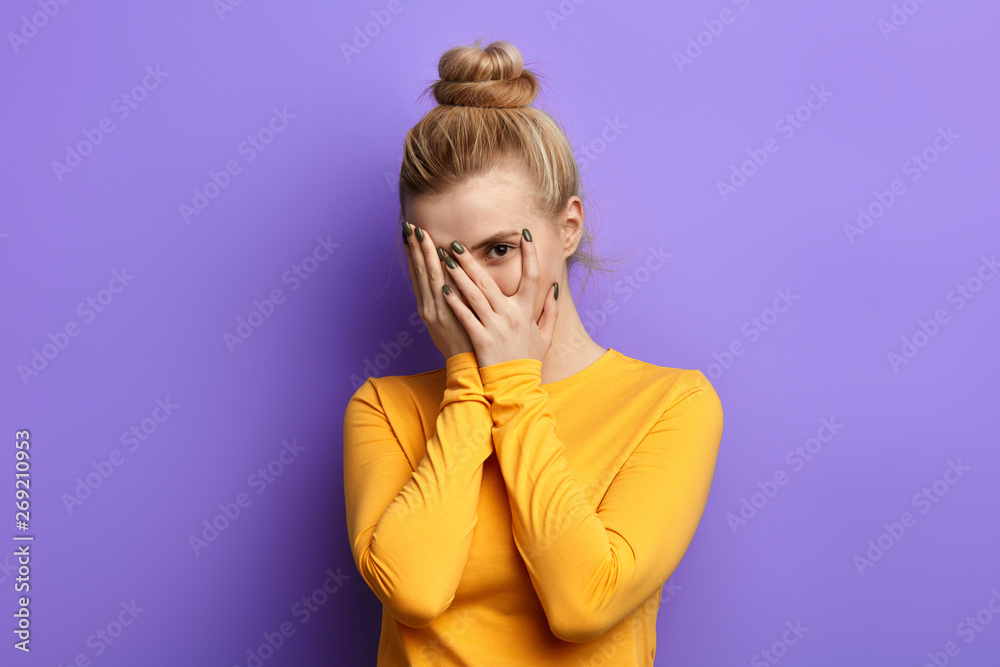 Stressed scared woman covering her face with palm, feeling afraid of ...