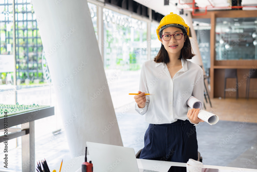 Happy beautiful asian female construction worker wearing yellow hard ...
