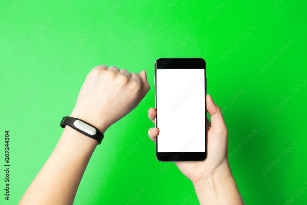 Female with tracker and mockup smart phone screen on green background ...