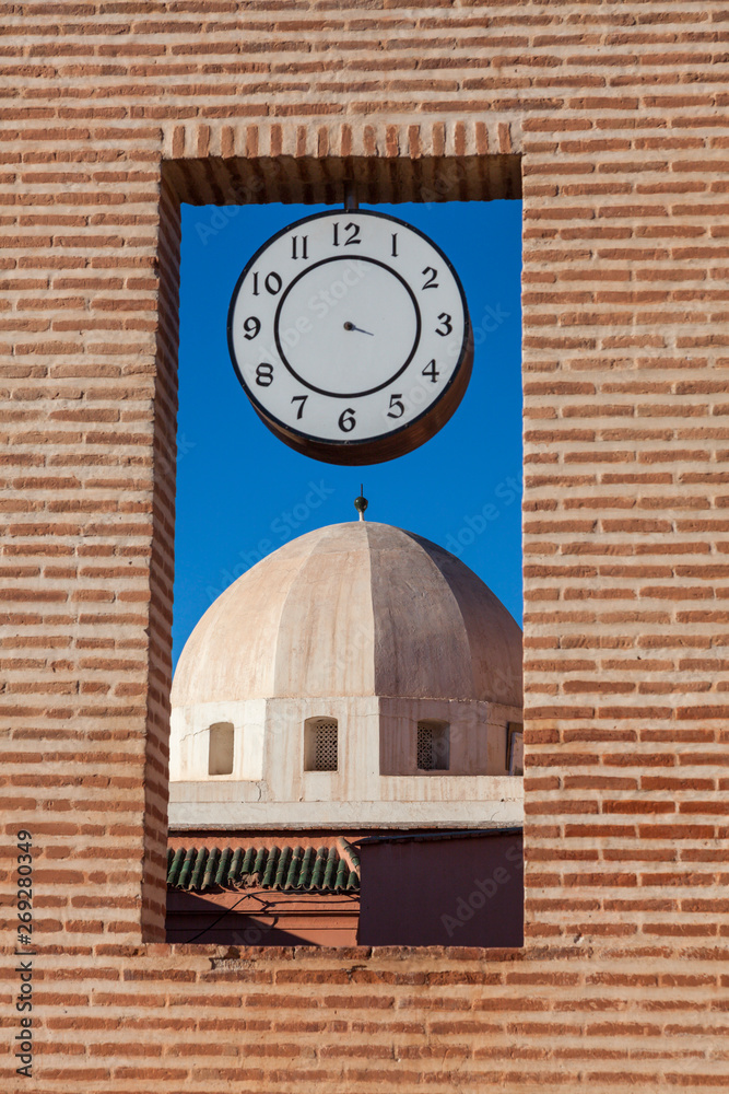 Dome behind brick window with clock in Marrakesh, Morocco Stock Photo ...