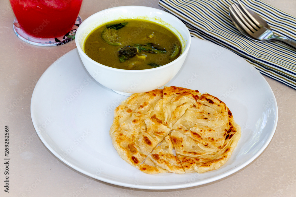 Crispy homemade roti - flat bread served with green curry - thai halal ...