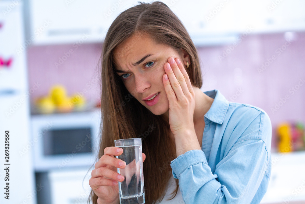 Sad unhappy young woman suffering from toothache at home. Teeth pain ...
