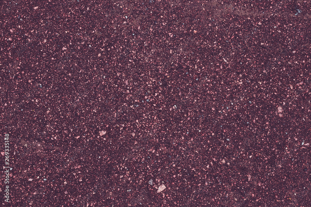 Abstract purple background of small pebbles, asphalt surface. Pink ...
