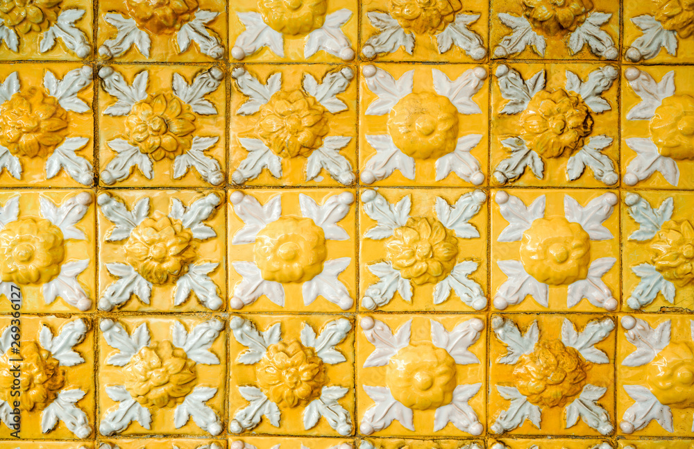Old and dirty bright yellow relief tiles with floral pattern. Vintage ...