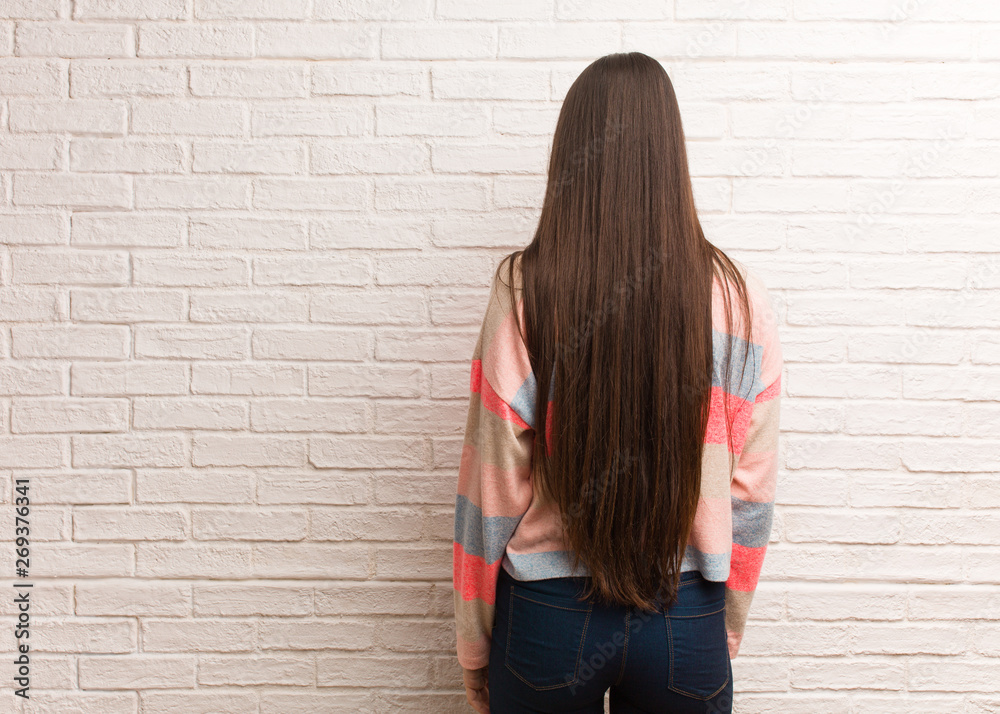 Young modern woman from behind, looking back Stock Photo | Adobe Stock