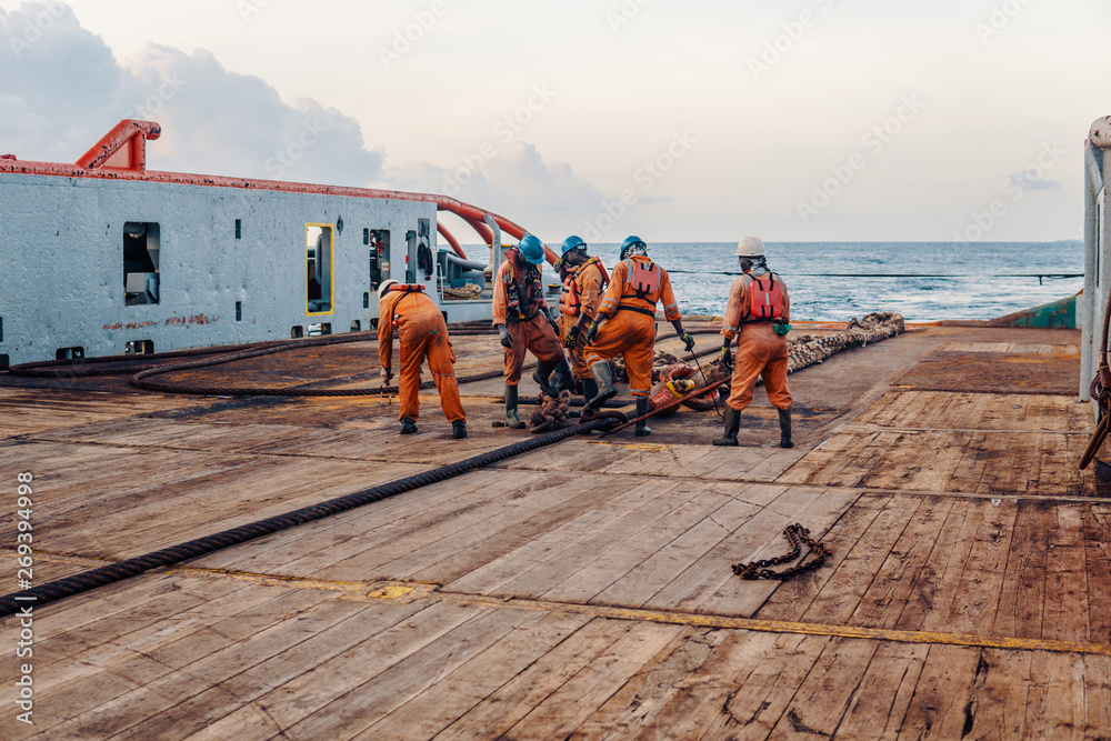 Anchor-handling Tug Supply AHTS vessel crew preparing vessel for static ...
