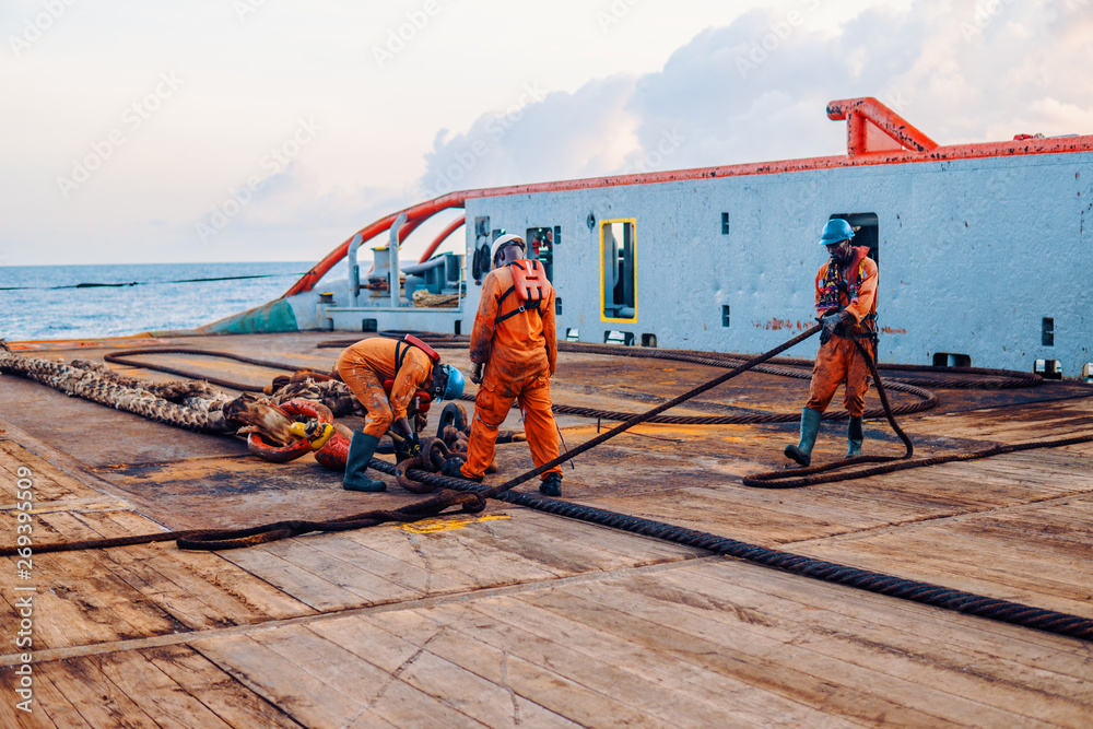 Anchor-handling Tug Supply AHTS vessel crew preparing vessel for static ...