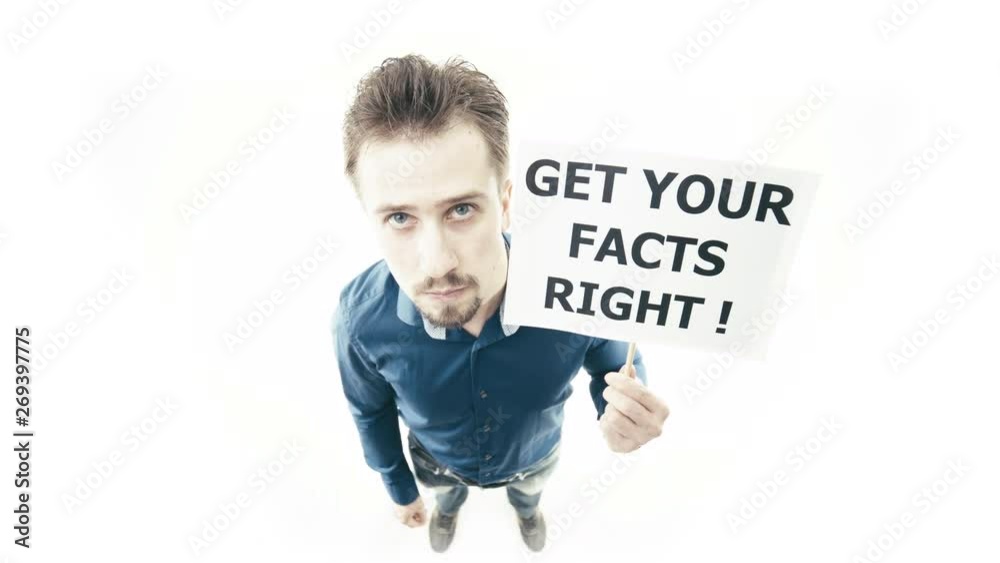 Man holding sign Get Your Facts Right 4K. Extreme wide shot top view of ...