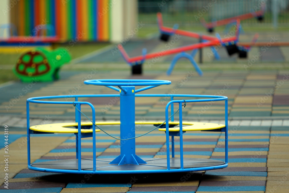 Beautiful playground in kindergarten with soft pavement, bright swings ...
