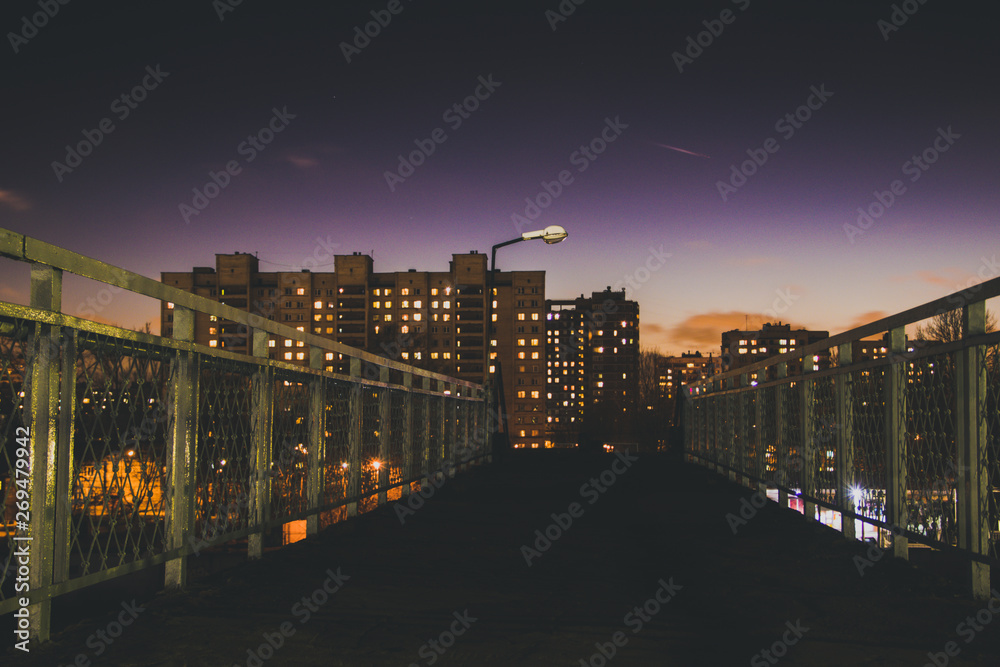 The lights of the night city. High houses at night. Light in the ...