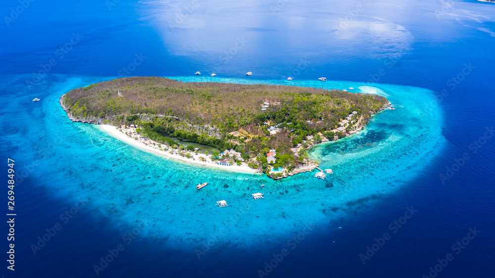 Aerial view of the Sumilon island, sandy beach with tourists swimming ...