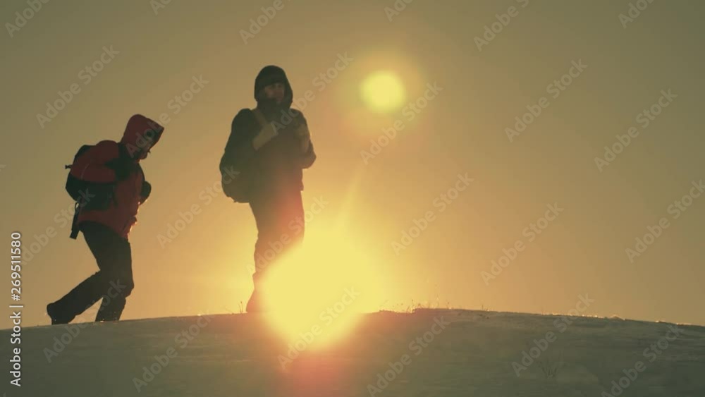 Tourist helping teammate climb, the man with the backpack reached out a ...