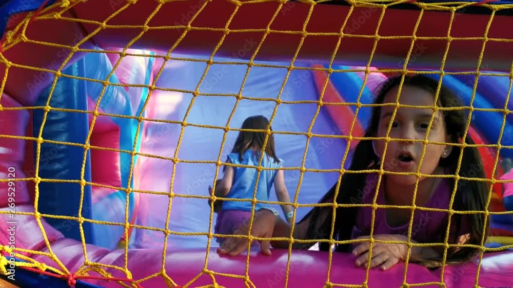Child jumping on colorful playground trampoline. Kids jump in ...