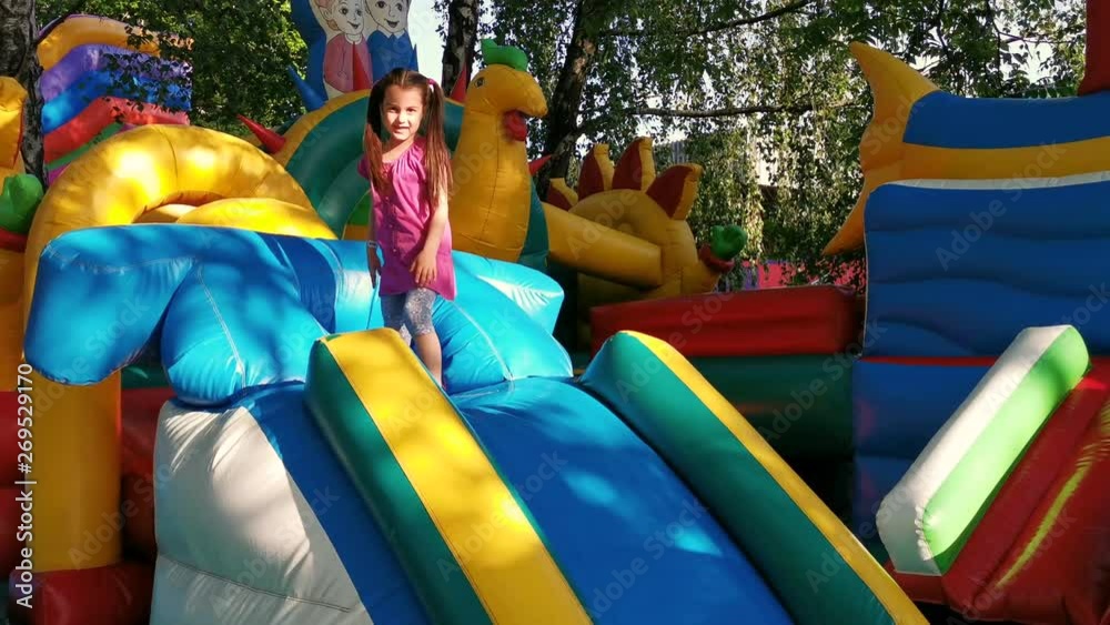 Child jumping on colorful playground trampoline. Kids jump in ...