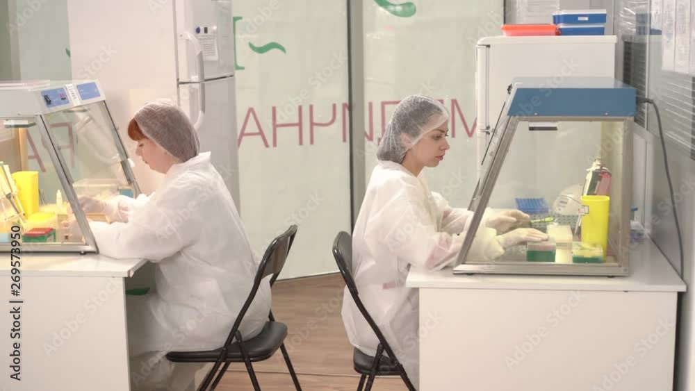 Left to right shot of laboratory scientists performing microbiology ...