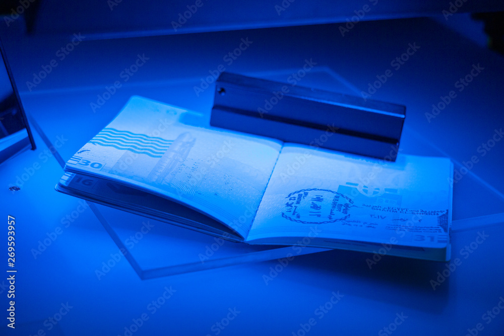 Checking the passport for fraud in UV and another light, detection of ...