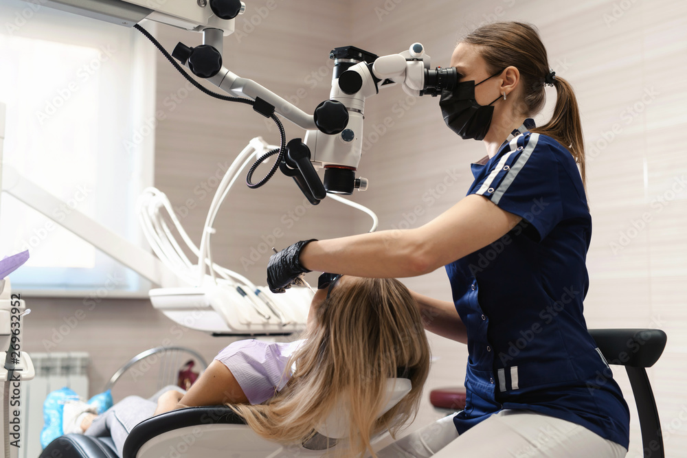 Doctor making teeth examination research survey using microscope in ...