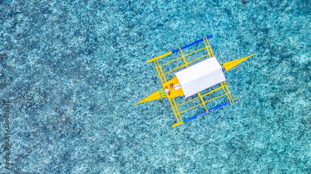 Aerial view of Filipino boats floating on top of clear blue waters ...