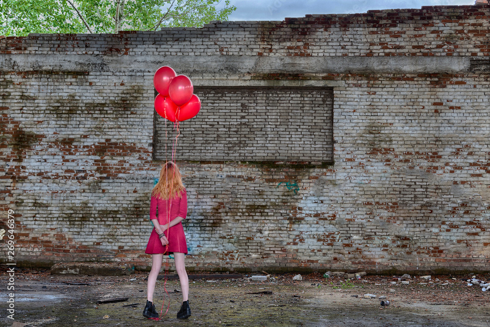 Beautiful girl in pink red dress with red helium balloons in hand ...