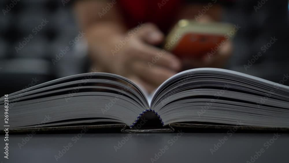 Reading old textbook in university library, read book or relaxing in ...