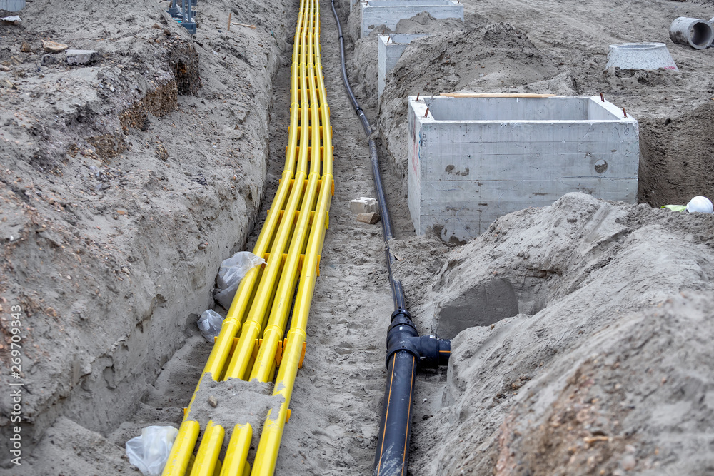 Yellow PVC pipeline for cable systems buried in the sand Stock Photo ...