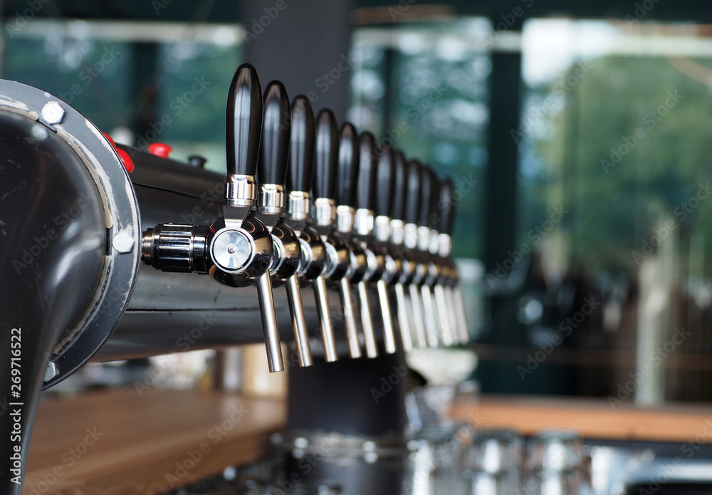 Craft beer tap system on the bar counter Stock Photo | Adobe Stock