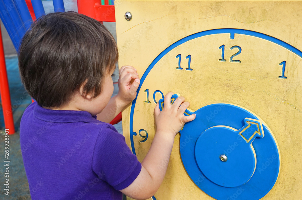 Child learning time with wooden clock at playground in summer, Kid boy ...