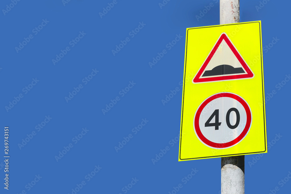 Speed Bump and 40 Speed limit traffic signs on the yellow shield. Road ...