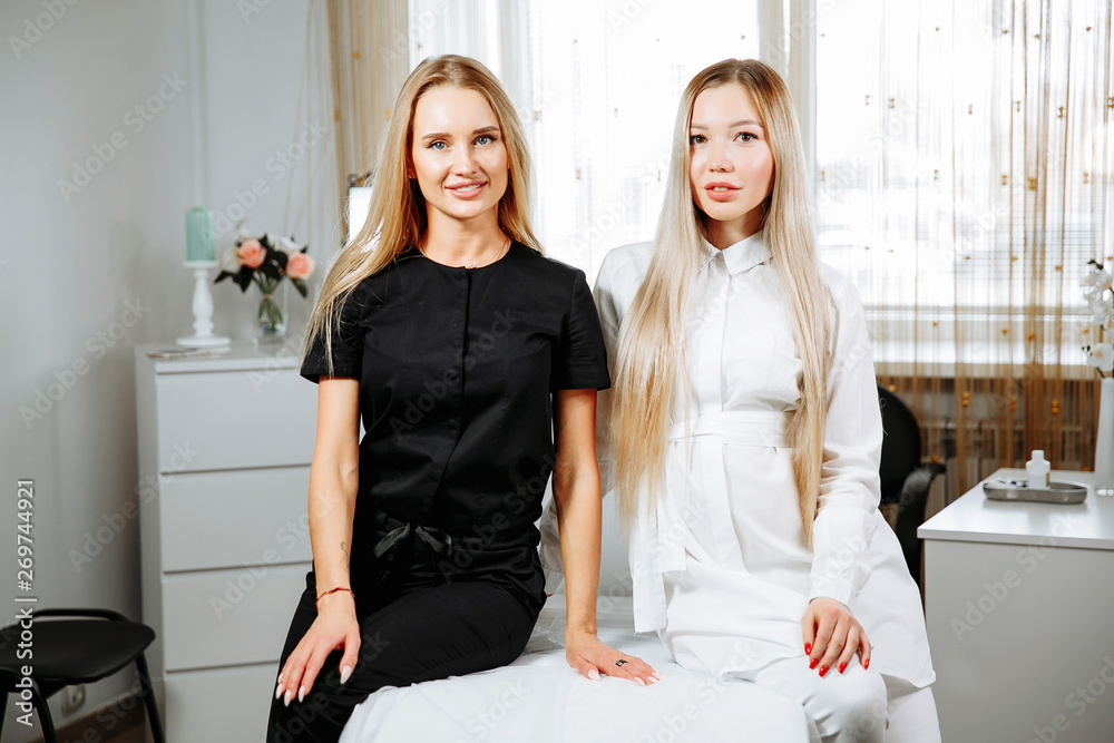 Two successful confident beauty salon female owners looking at camera ...