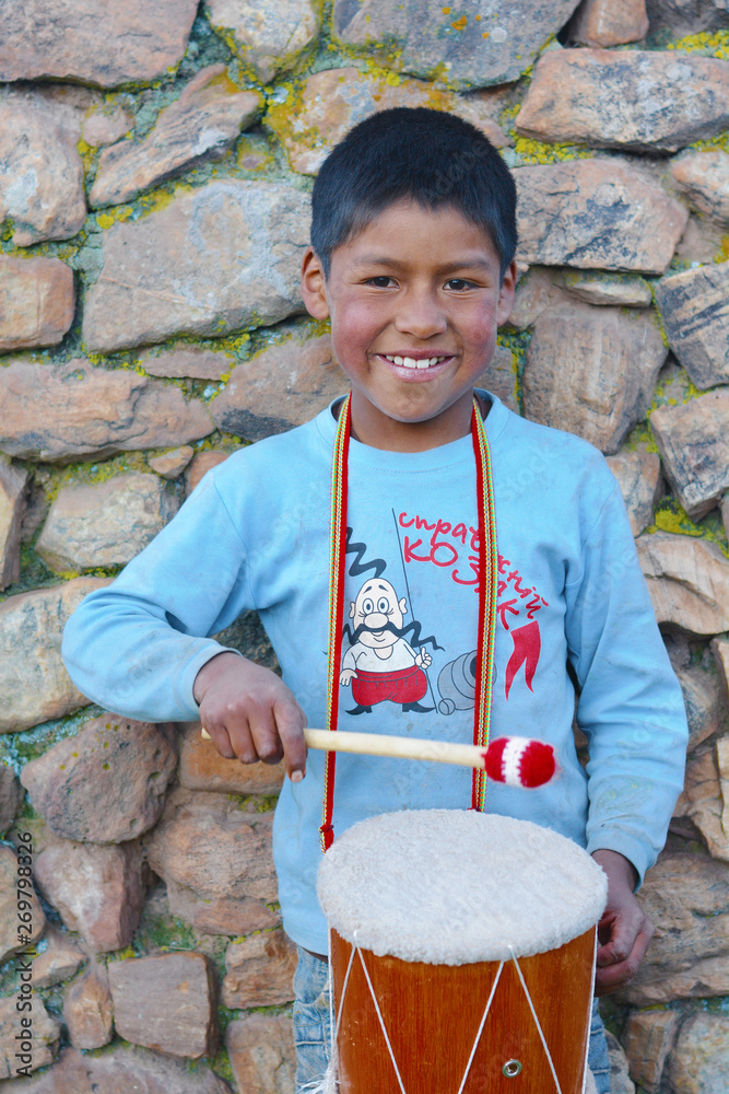 Little native american boy playing traditional sikuri drum. Stock Photo ...
