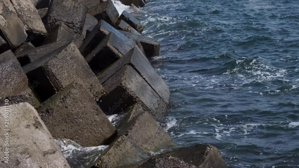 Destroyed coastal concrete protective structure. Large deep cracks ...