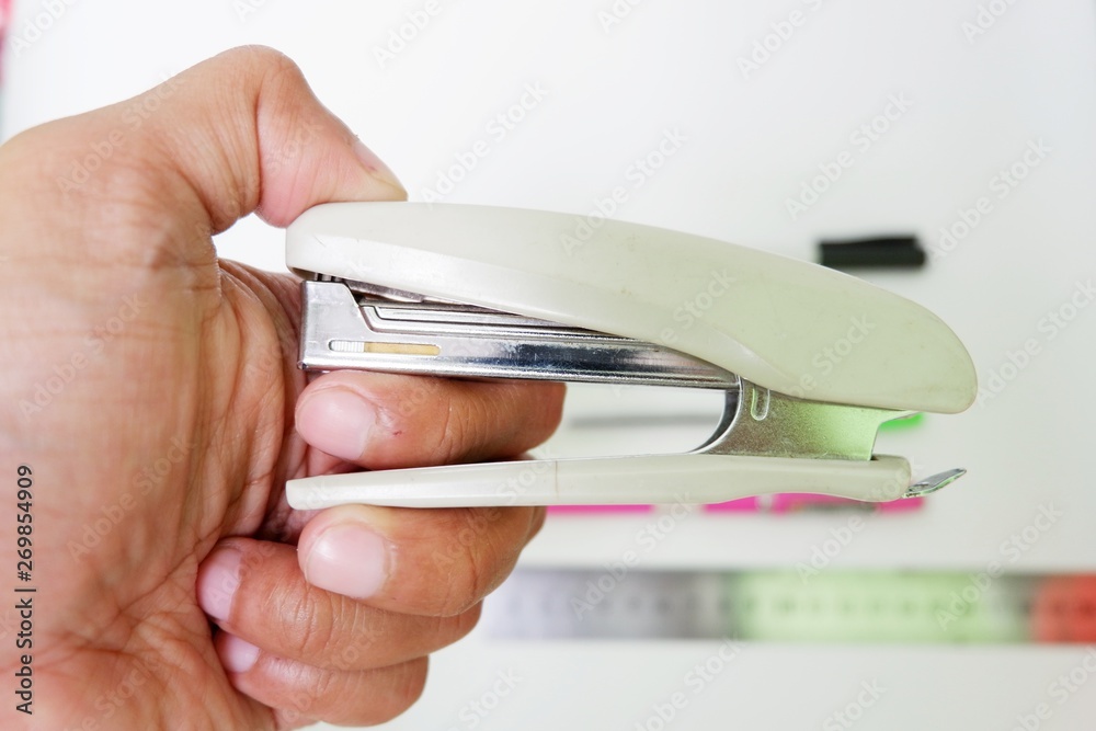 A man finger is pinched in the stapler.It is very dangerous. Stock ...