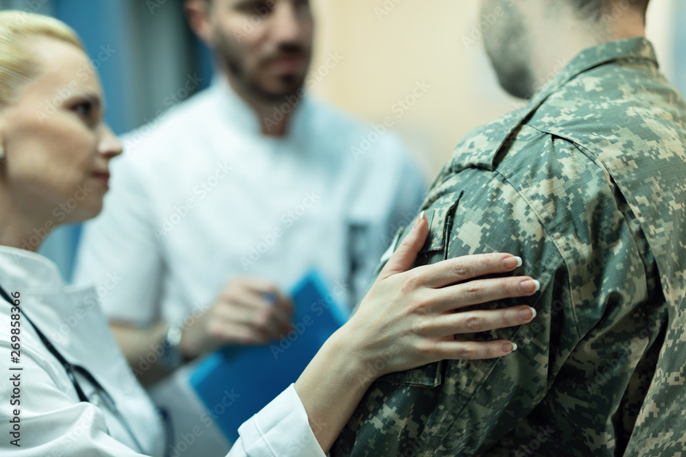 Close up of doctors consoling military officer in the hospital. Stock ...